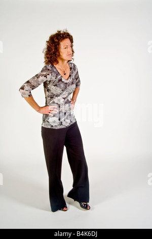 Standing with hands on her hips indicates readiness and aggression via ...