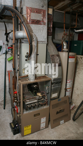 Old gas heater, gas furnace for central heating with pipes and wires ...