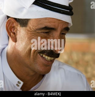 Smiling, happy Arab man in dishdasha, traditional clothing worn by ...