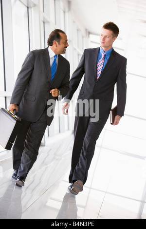 Two CEO businessmen walking and talking in the city. Business men ...