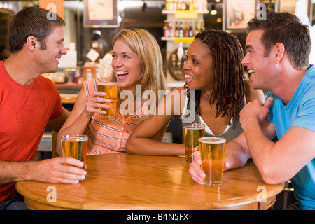 Two couples having beer together Stock Photo - Alamy
