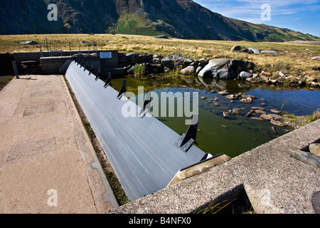Tilting gate weir and dam across river Afon Eigiau controlling water ...