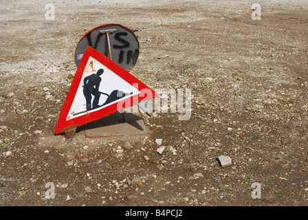 Triangular warning 'Man at Work' sign cautioning of grass cutting in ...
