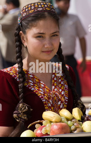 Turkmen girl offering food at a reception for delegates at an ...