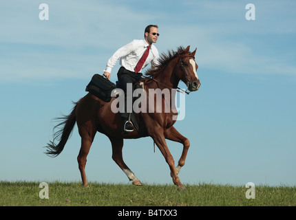 Businessman, manager with a bag, riding a horse Stock Photo - Alamy