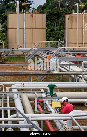 Onshore oil processing plant showing pipework and tanks with oil ...