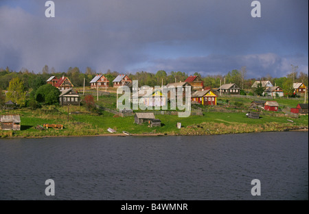 A small dacha farm in a riverside village under a stormy autumn sky ...