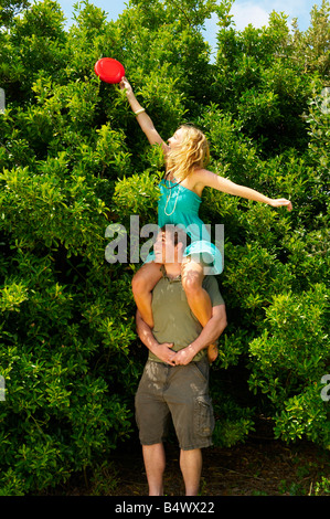 Couple with woman pulling on man's tie, close-up Stock Photo - Alamy