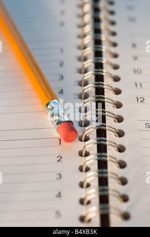 Blank notebook and pencil on color background Stock Photo - Alamy