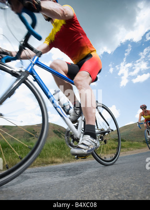 Cyclists riding together on a country road Stock Photo - Alamy