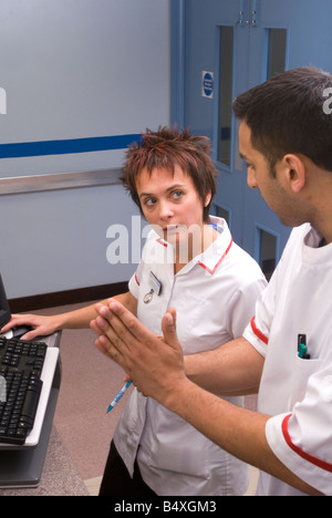 two serious radiographers talking while examining radiology diagnosis ...