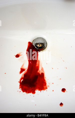 Blood flows into the drain of the sink. The blood is beginning to ...