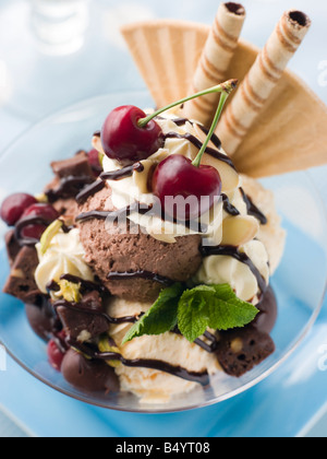 ice cream sundae in chocolate glaze in a plate on a blue background ...