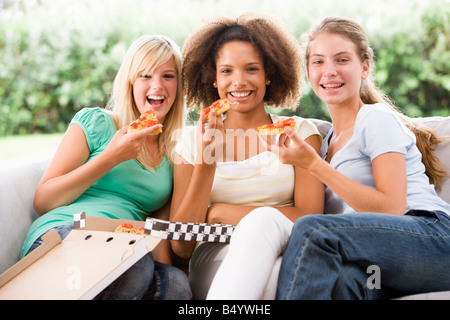 Eating Fast Food. Happy three Beautiful Friends Laughing, Eating Pizza ...