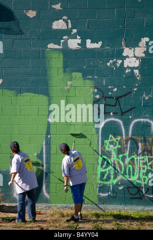 Volunteers Paint Over Graffiti Stock Photo - Alamy