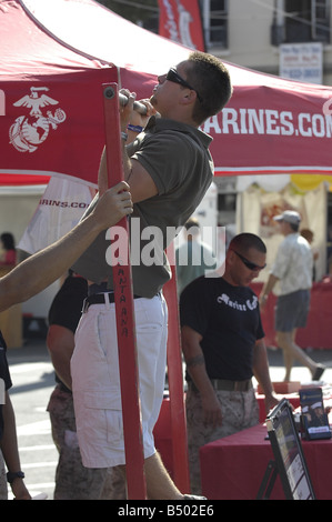 Visitors to a US Marine Corps recruiting booth at a street fair ...