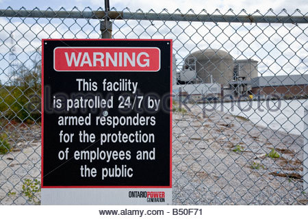 An armed response security sign on the side of a building in the Stock ...