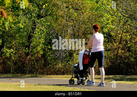 A mother pushes her baby in a stroller wearing gas masks Stock Photo ...