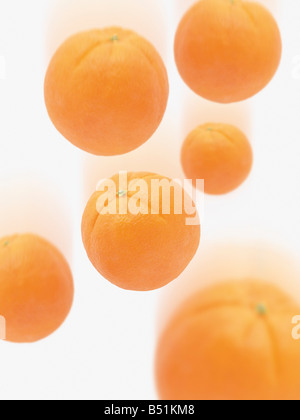 A closeup shot of fresh oranges falling out of a bowl Stock Photo - Alamy