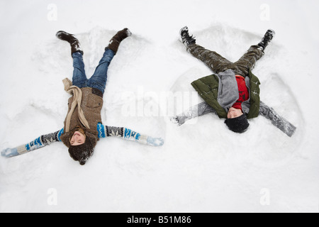 happy little kids making snow angels in winter Stock Photo - Alamy