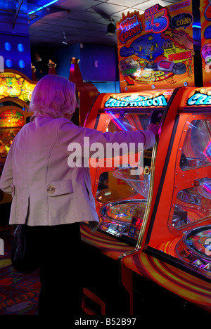 Senior woman playing slot machines in casino on cruise ship-Pacific ...