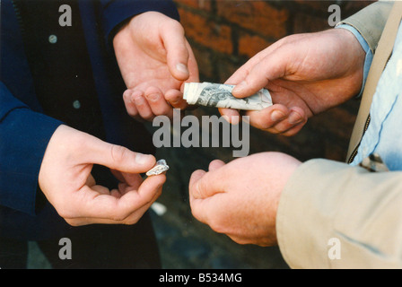 Models illustrating buying drugs drug dealing in a alleyway or street ...