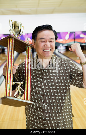 Asian man with bowling trophy Stock Photo - Alamy