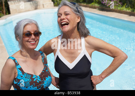 Friends at poolside in bathing suits and sunglasses Stock Photo - Alamy