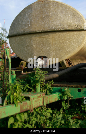 overgrown water tank Stock Photo - Alamy