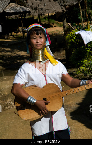 A colorful Padong woman plays a traditional string music instrument ...
