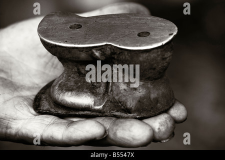 A gaucho holds a taba which is used to play the traditional game of the ...