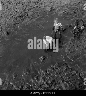 The mud-larkers: These boys at Portsmouth Harbour do a mud-lark turn to ...