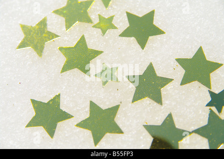 golden snow stars on a real snowy icy surface Stock Photo - Alamy