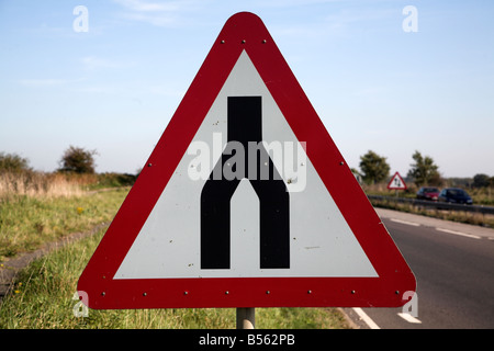 Road sign warning sign of dual carriageway ending speed reduction ...