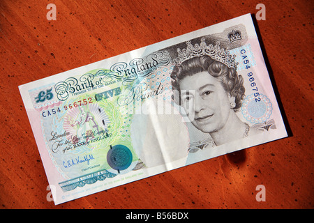 Five pound British currency note on table showing Queen Elizabeth II ...