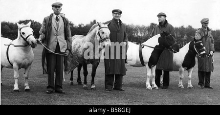 Miners at Langley Park Colliery on their way to work stop for a glance ...