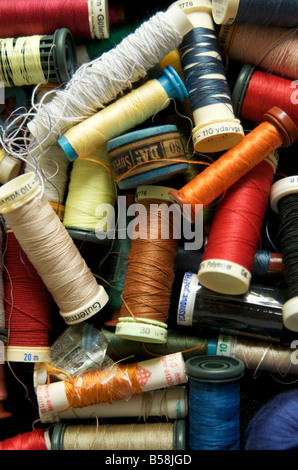 Piles of colourful threads Stock Photo - Alamy