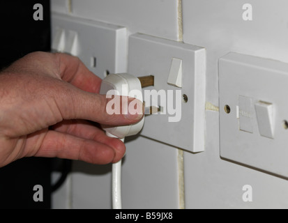 Unpluging a plug Stock Photo - Alamy
