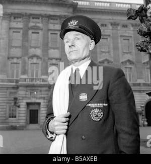 The Royal Postman stands at the gates to Buckingham Palace before ...