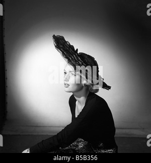 Woman modelling the latest 1956 hat fashions in the Reveille studios ...
