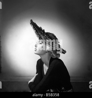Woman modelling the latest 1956 hat fashions in the Reveille studios ...