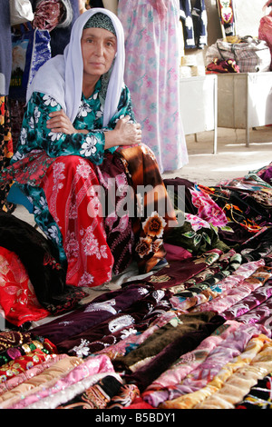 Uzbek woman selling textile, market in Osh, Kyrgyzstan, Central Asia ...