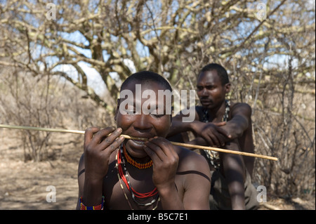 Hadza men bending a hunting arrow over a fire Lake Eyasi Tanzania Stock ...