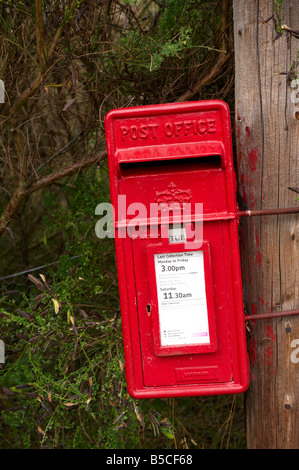 Freshly painted bright red Royal Mail post box with gold lettering ...