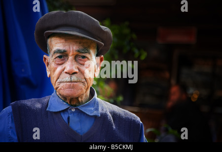 A portrait of the face head and shoulders of an elderly old Turkish man ...