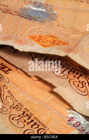 Old Ten pound notes still in circulation frayed torn and dirty at the ...