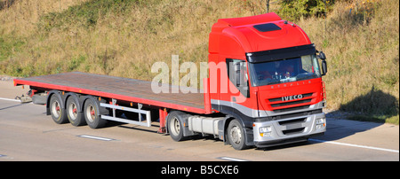 M25 motorway flat back lorry travelling empty Stock Photo - Alamy