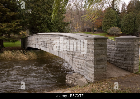 A narrow stone bridge stretches over a creek Stock Photo - Alamy