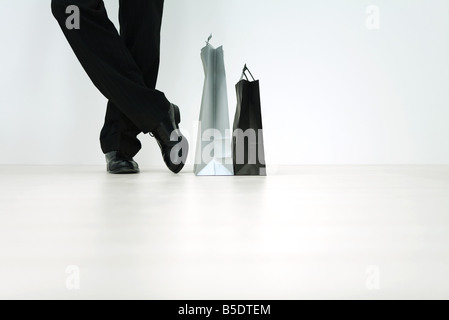 cropped view of man standing near car and touching handle while opening ...