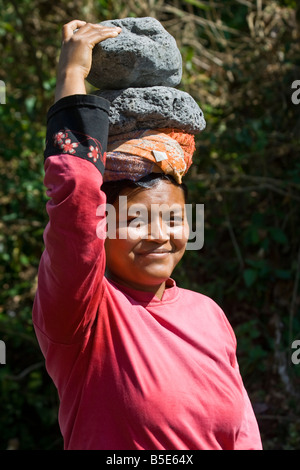 Woman carrying heavy stones on Lombok Island in Indonesia Stock Photo ...